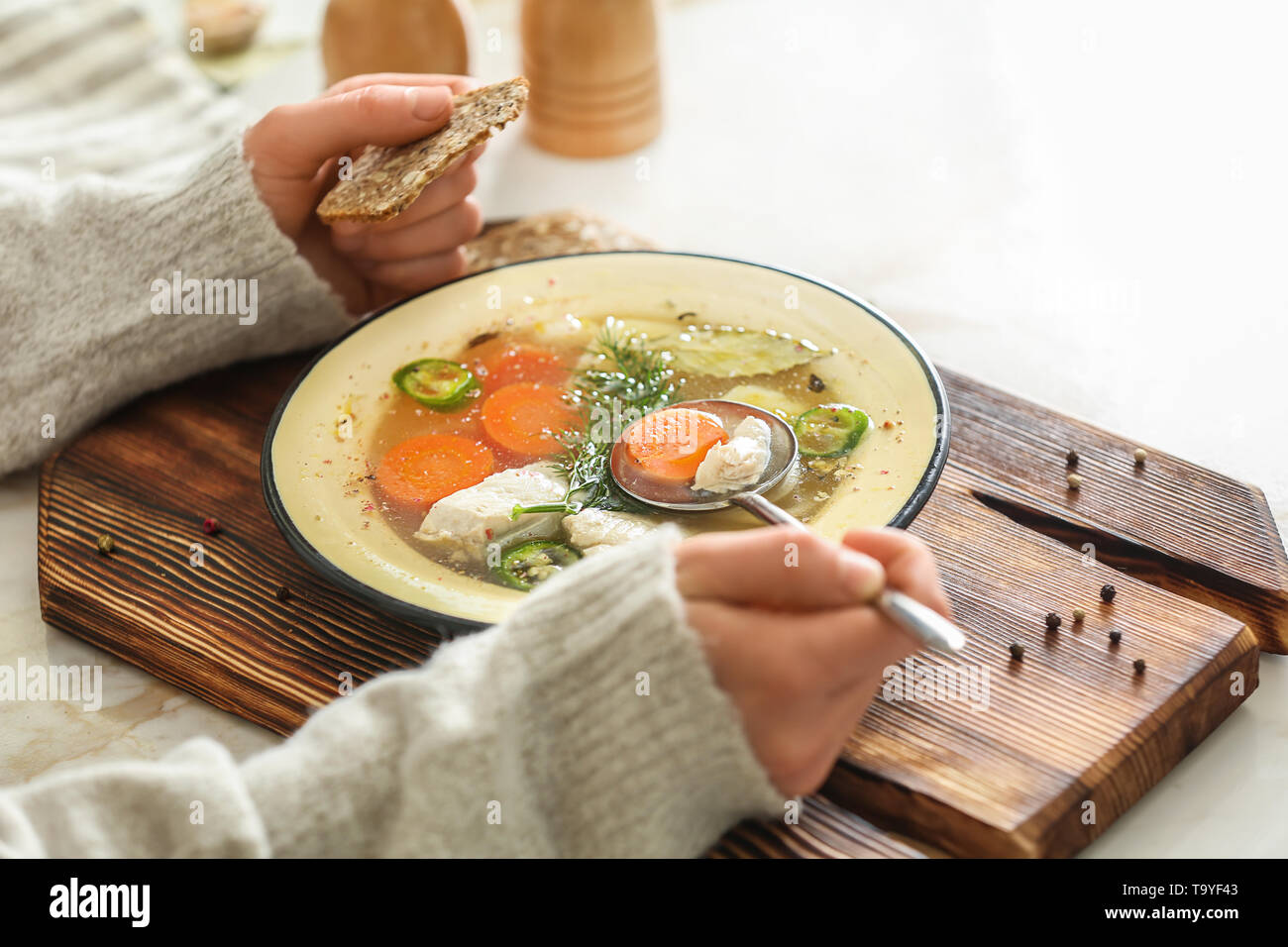 Woman eating soup broth hi-res stock photography and images - Alamy