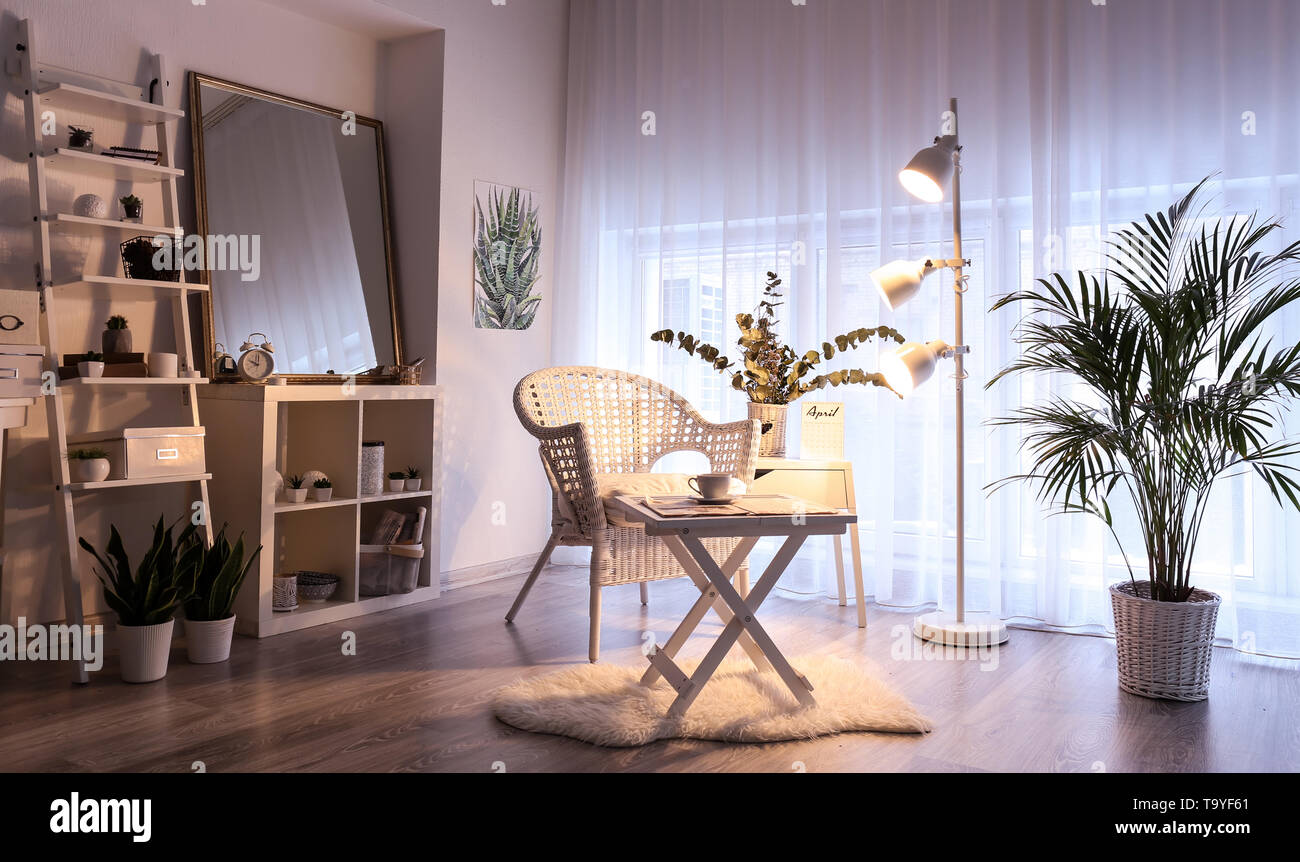 Interior of beautiful room with table and armchair Stock Photo - Alamy