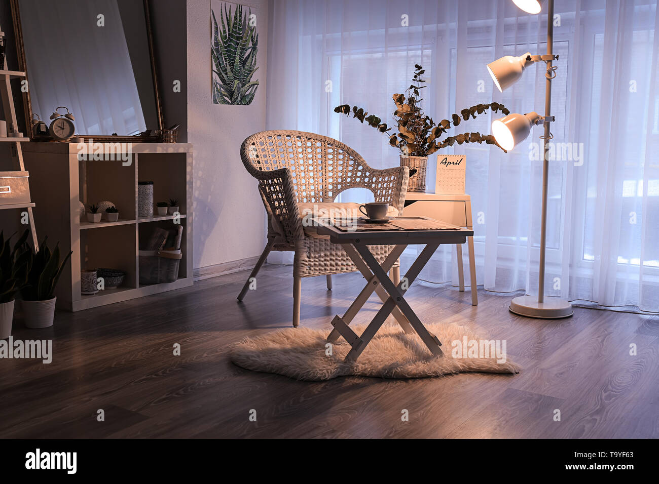 Interior of beautiful room with table and armchair Stock Photo - Alamy