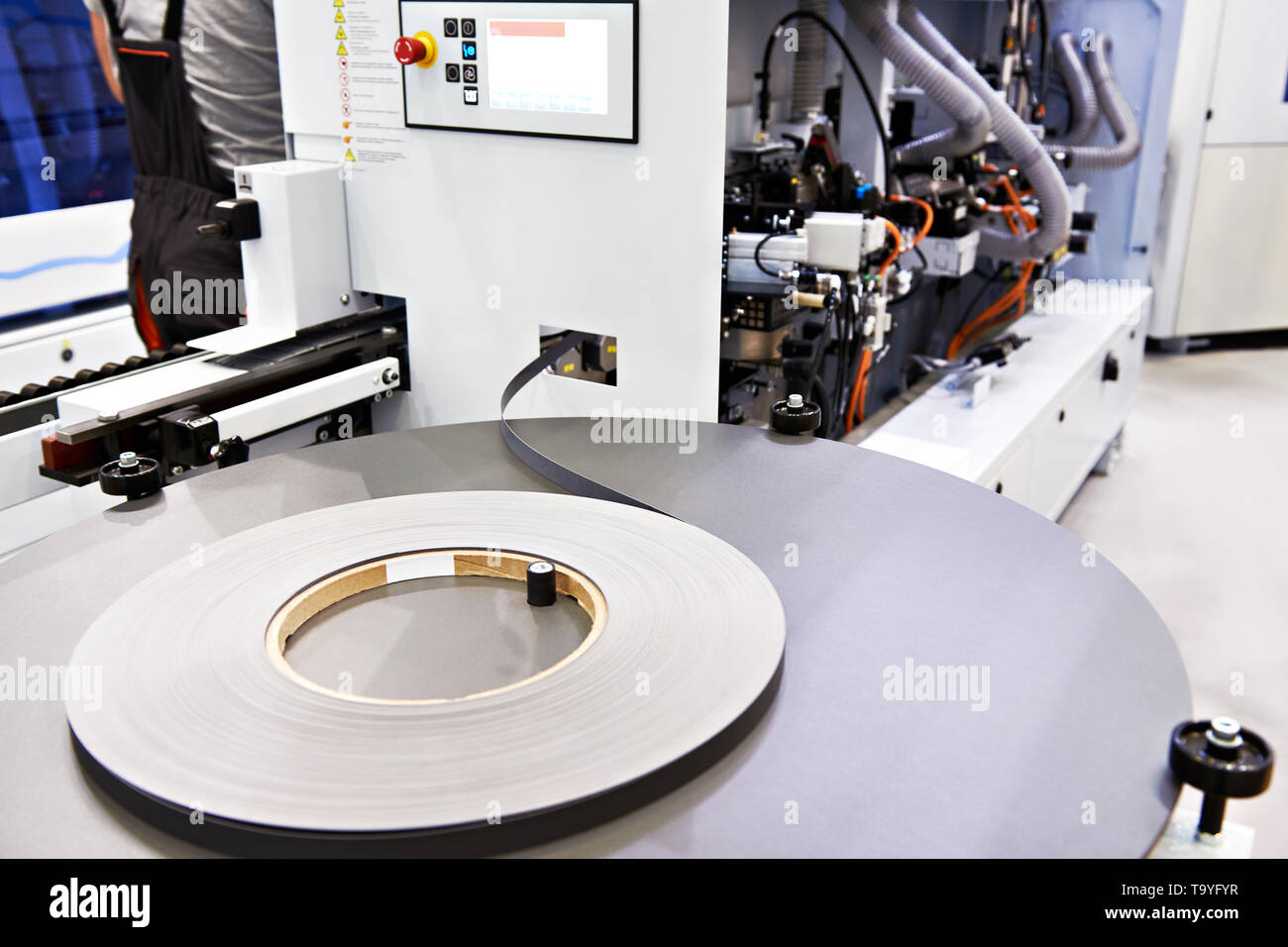 Single sided automatic edge banders on factory Stock Photo - Alamy