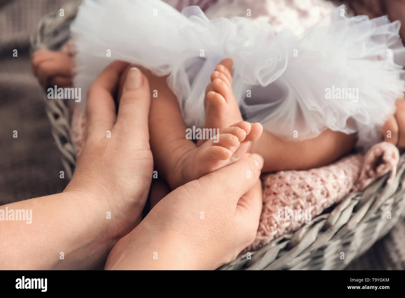 Mother's hands holding tiny feet of little baby, closeup Stock Photo ...