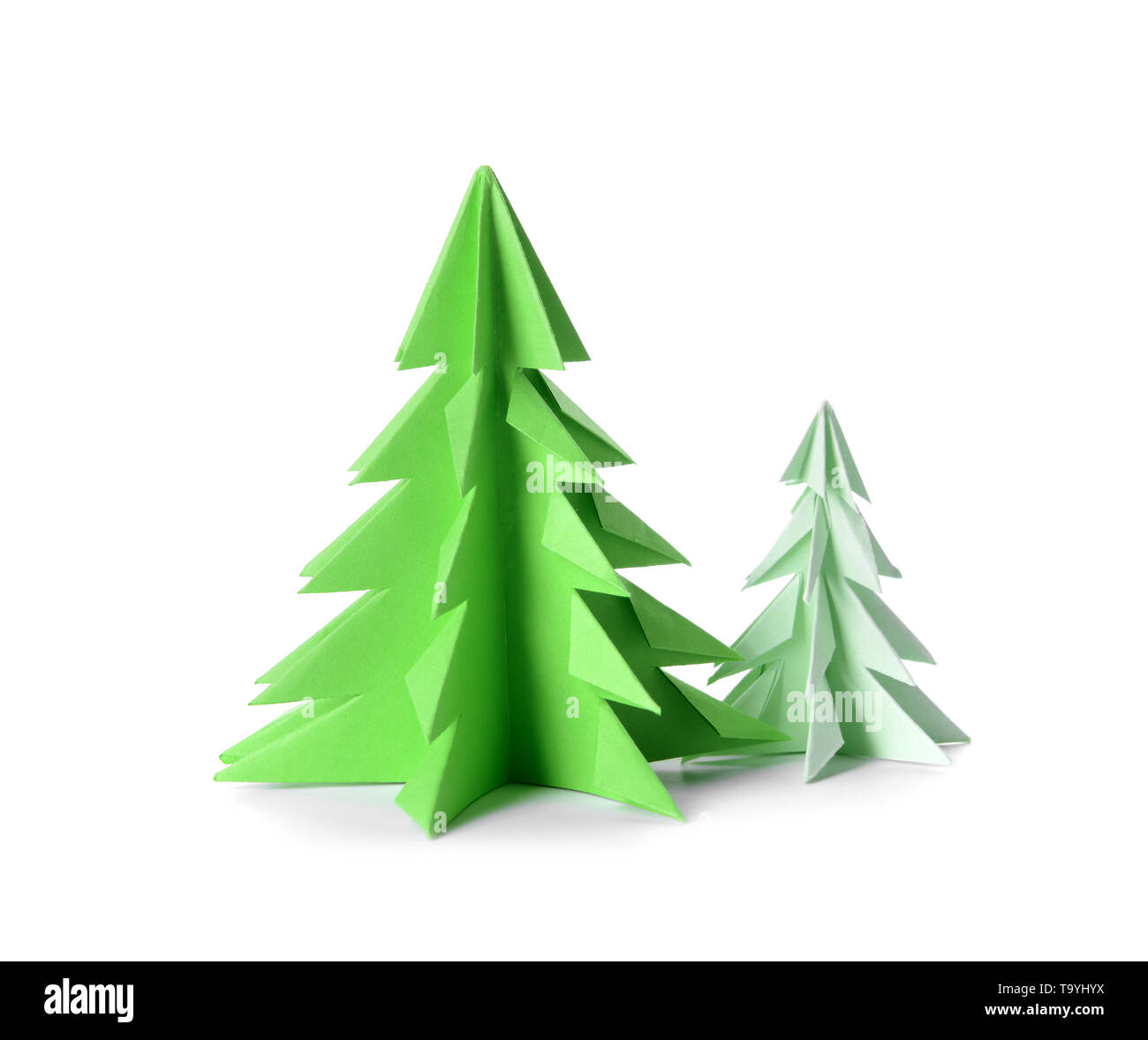 Green origami fir trees on white background Stock Photo - Alamy
