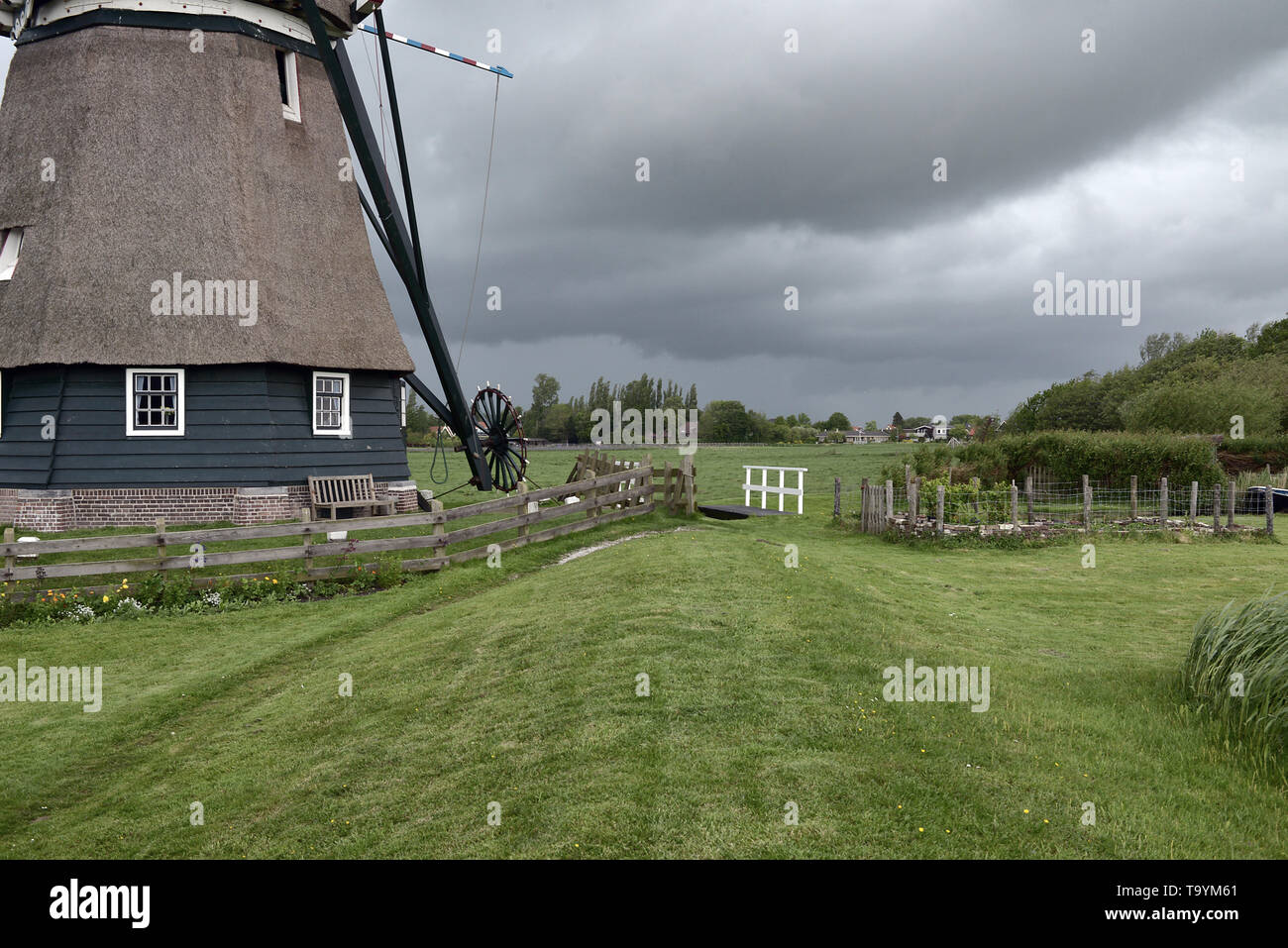 Stunning image of a traditional Dutch windmill in a beautiful landscape ...