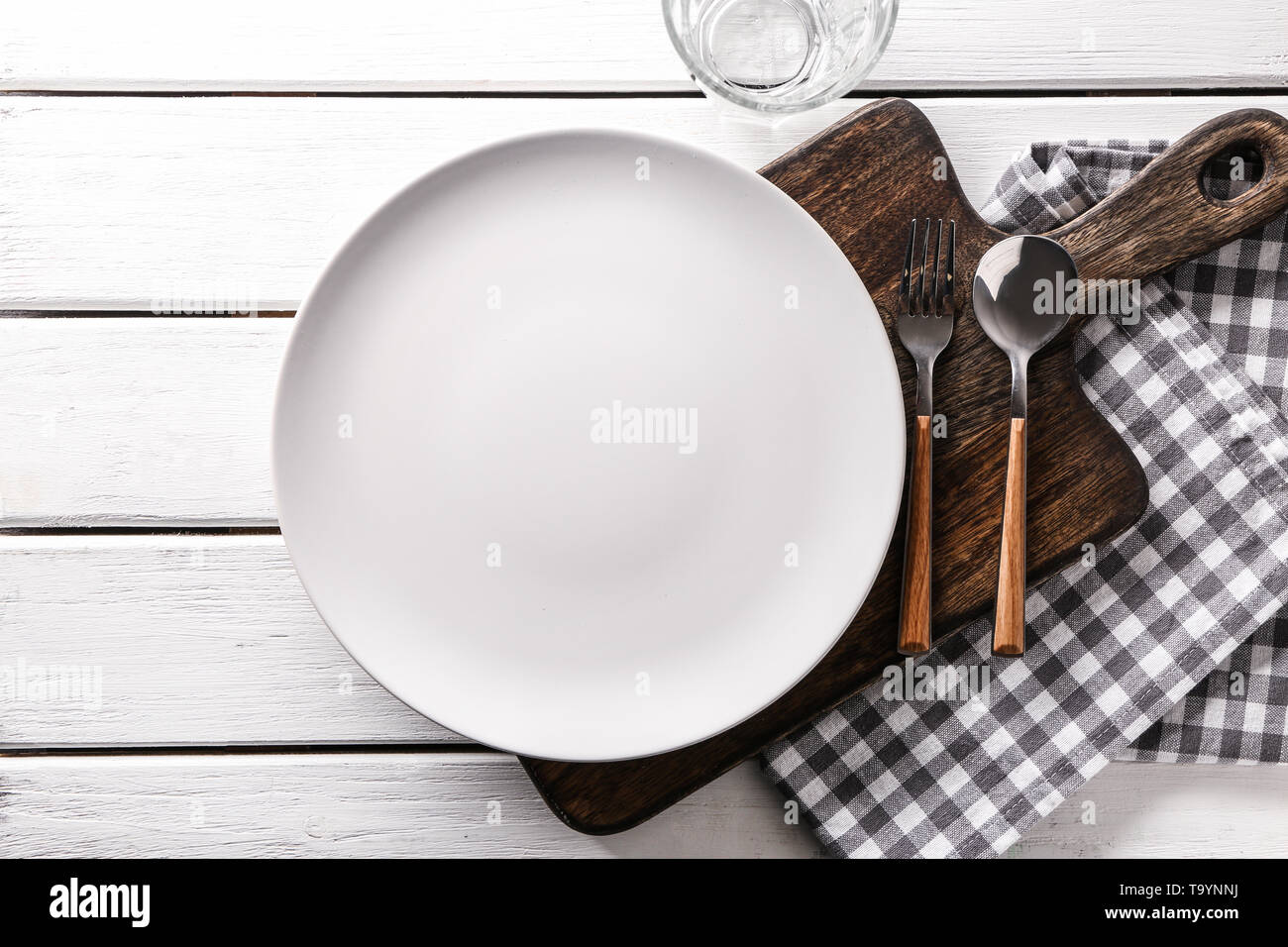 Simple table setting on wooden background Stock Photo - Alamy