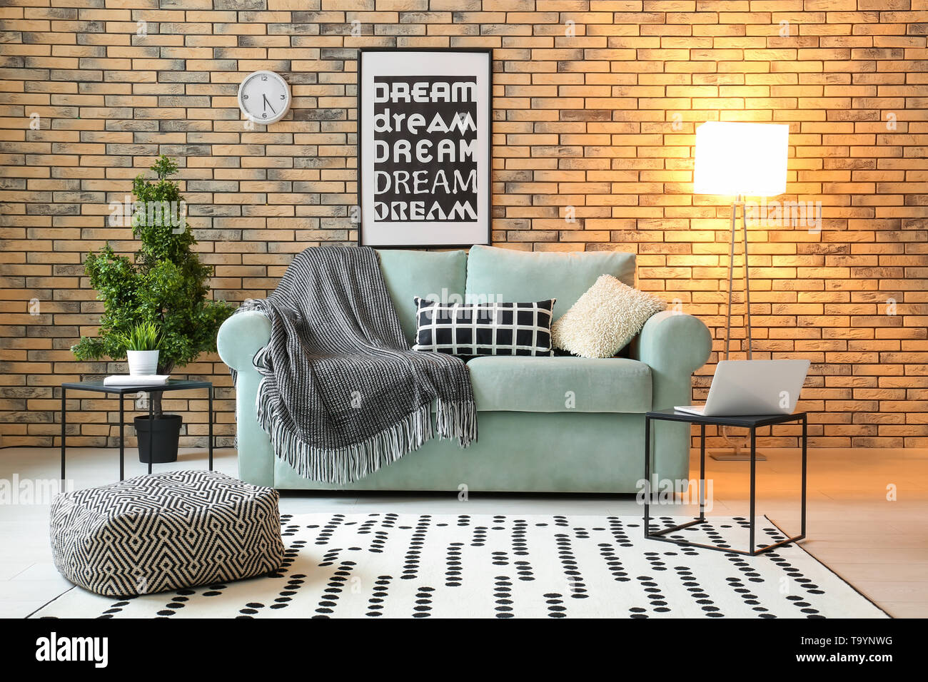 Stylish interior of living room with comfortable sofa Stock Photo - Alamy