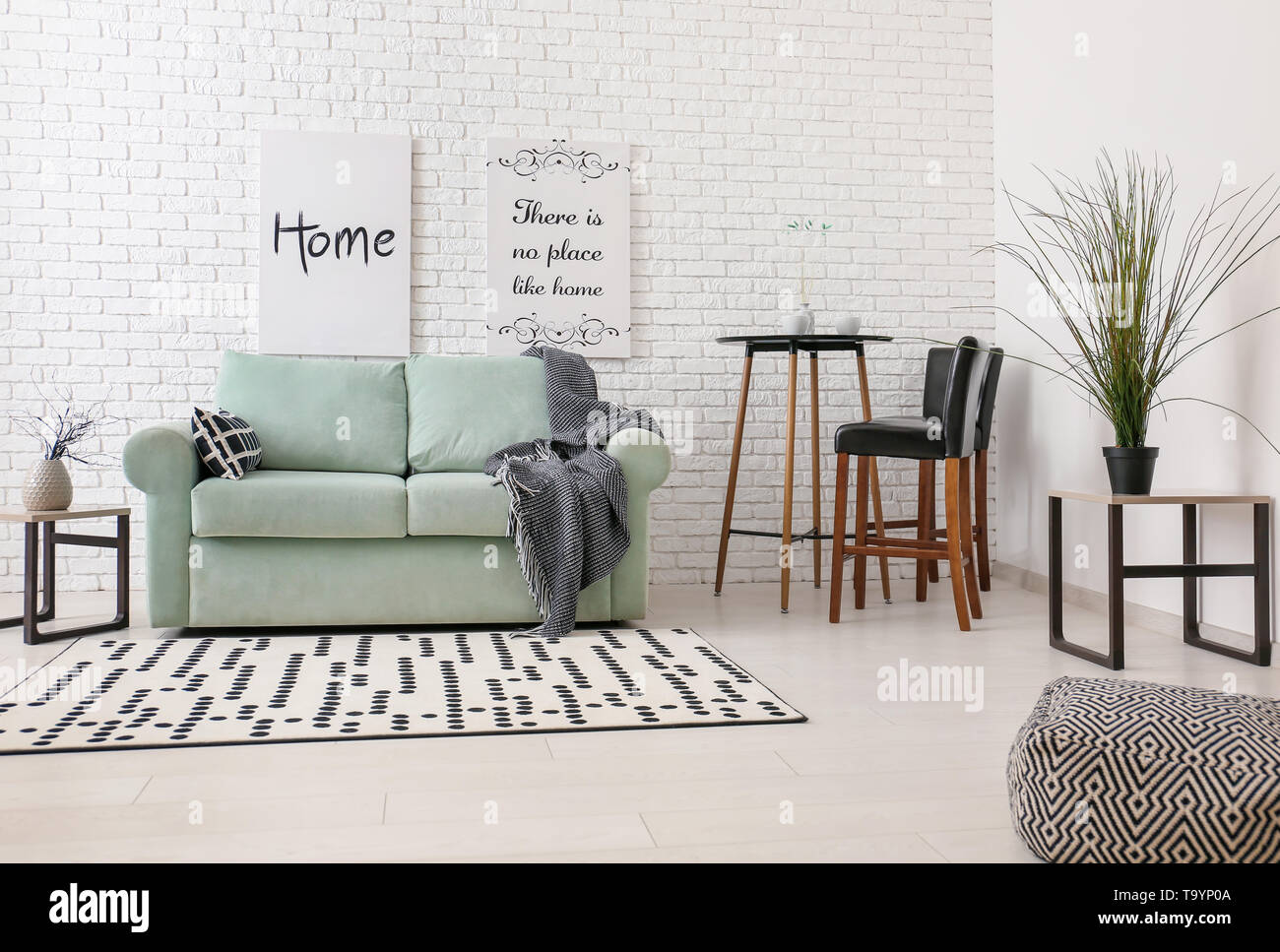 Stylish interior of living room with comfortable sofa Stock Photo - Alamy