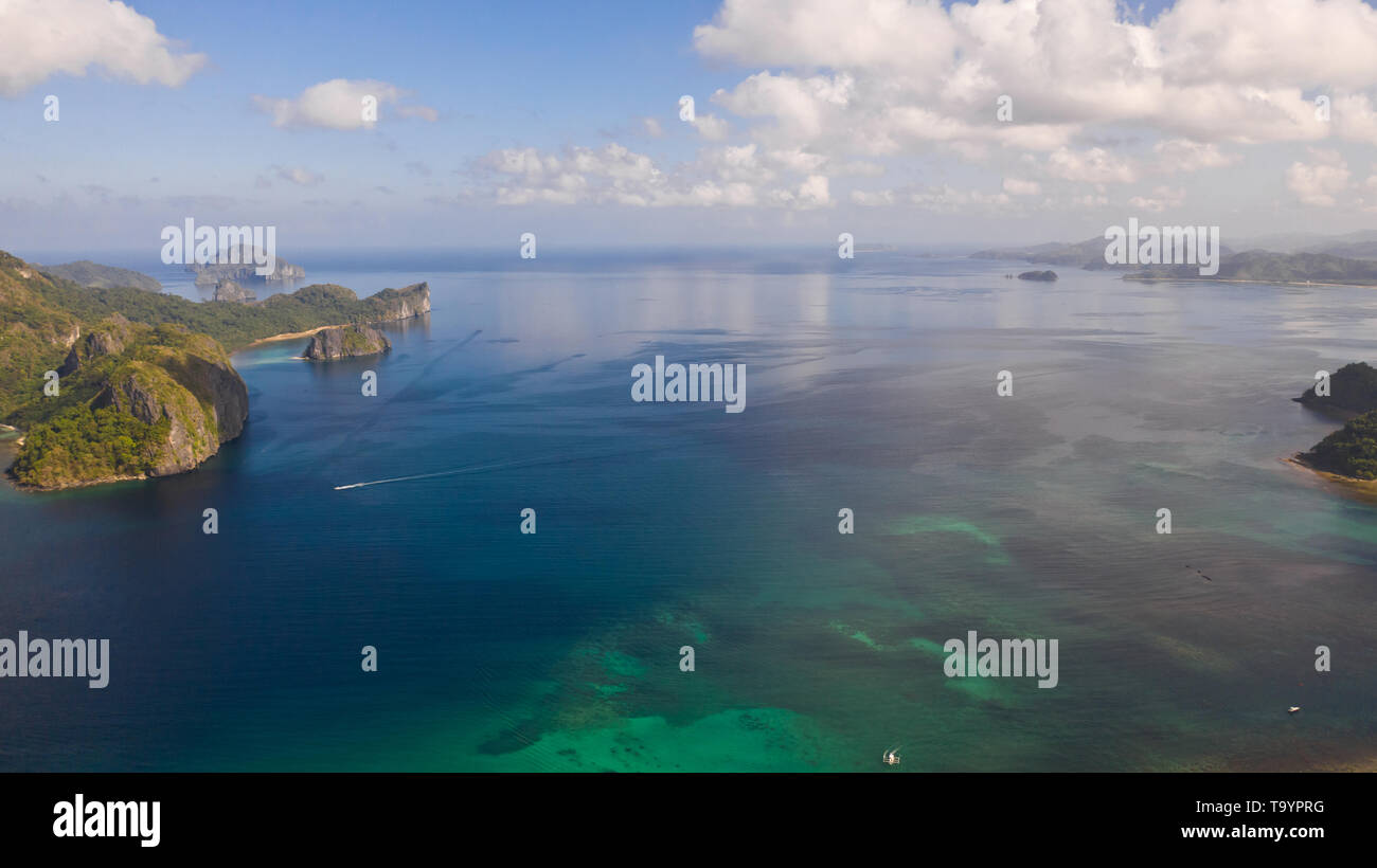 Seascape, view from above. Rocky islands covered with rainforest. El ...