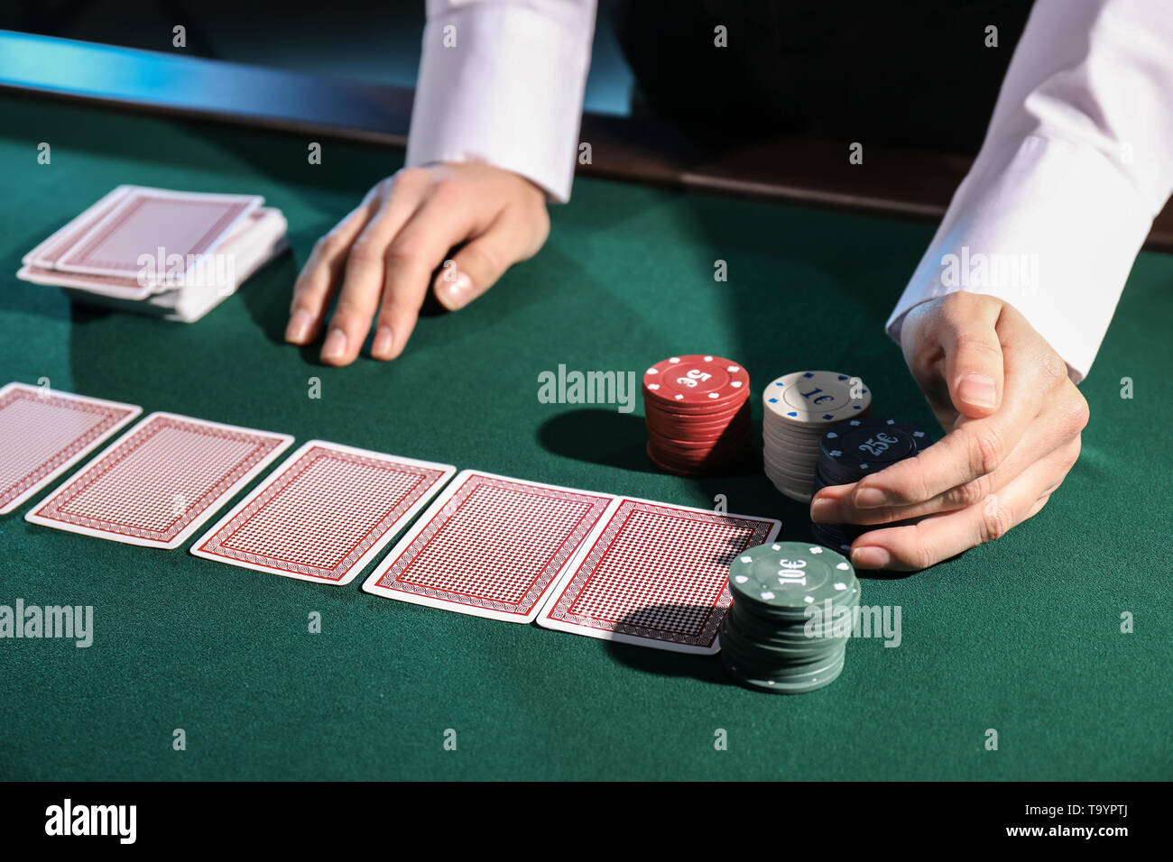 Female banker with cards and chips at table in casino, closeup Stock ...