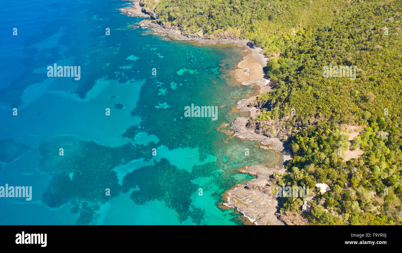 Coast of frozen lava and blue lagoon with corals, top view.Coast of ...