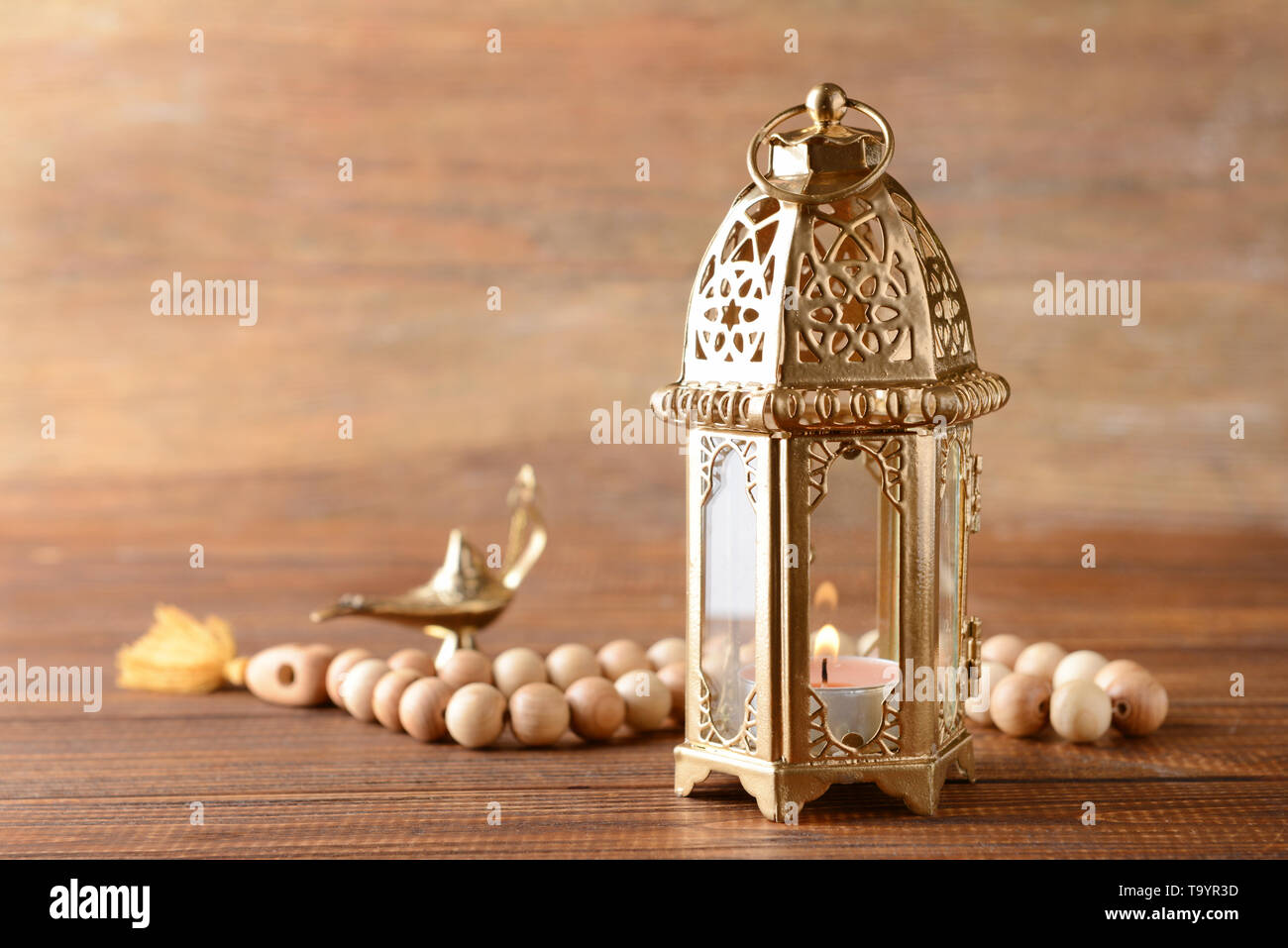 Muslim lamps and tasbih on wooden table Stock Photo - Alamy