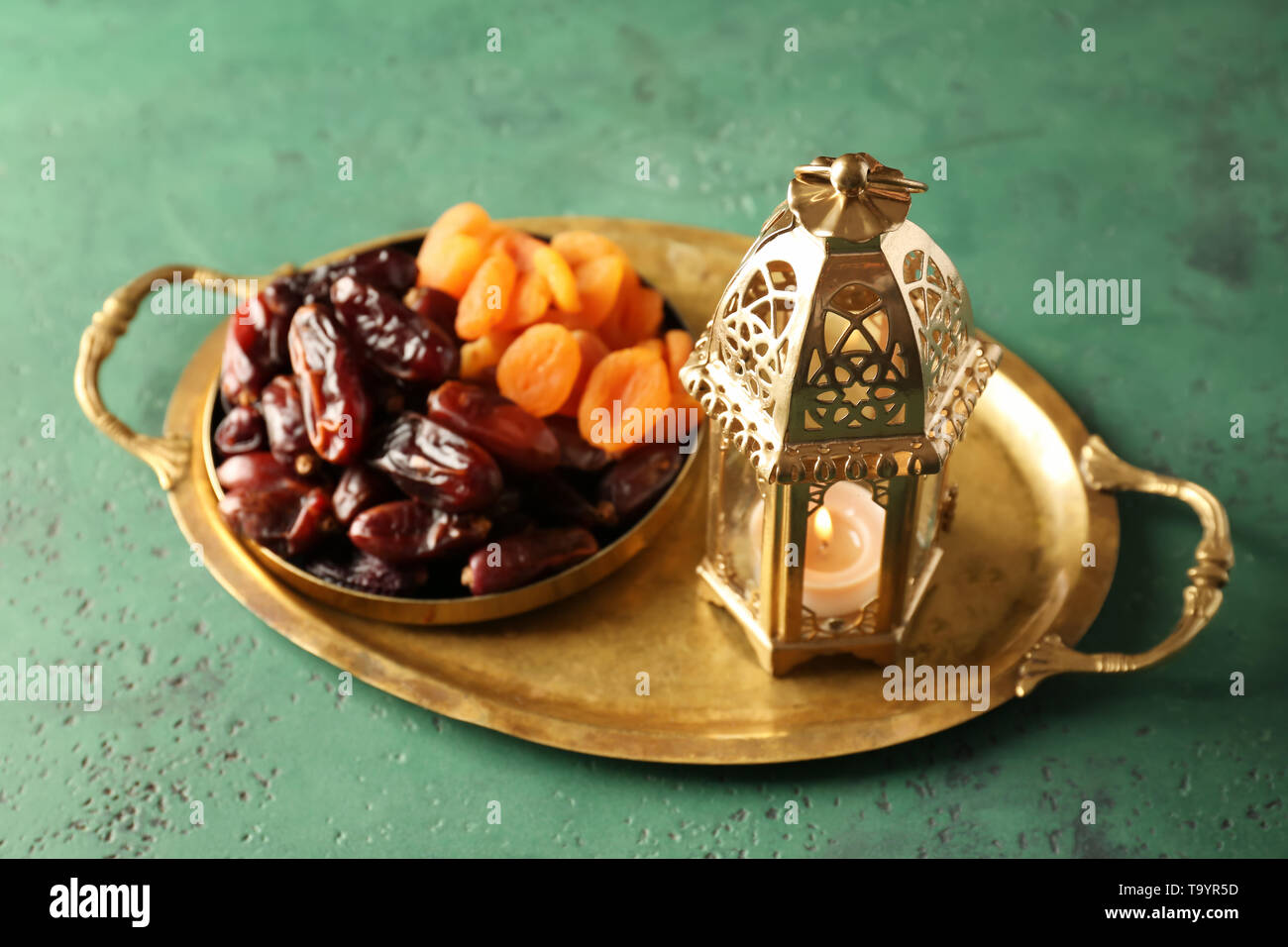 Composition with Muslim lamp and dried fruits on table Stock Photo - Alamy