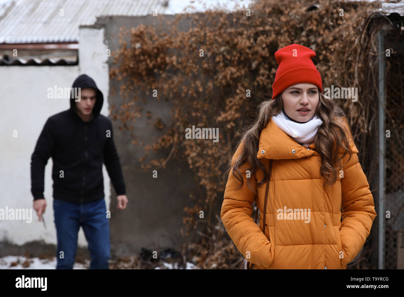 Male thief following young woman outdoors Stock Photo - Alamy