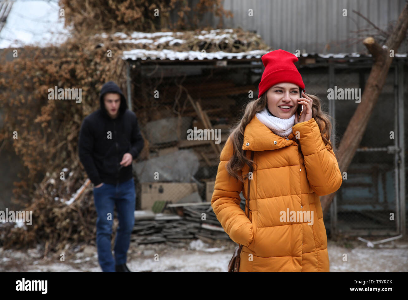 Male thief following young woman outdoors Stock Photo - Alamy