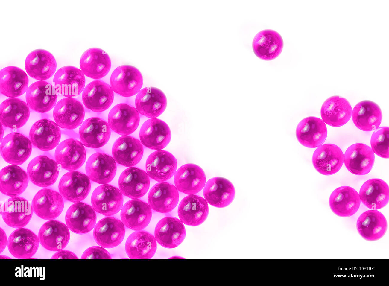 plastic pink spherical ball capsules with selective focus isolated on ...