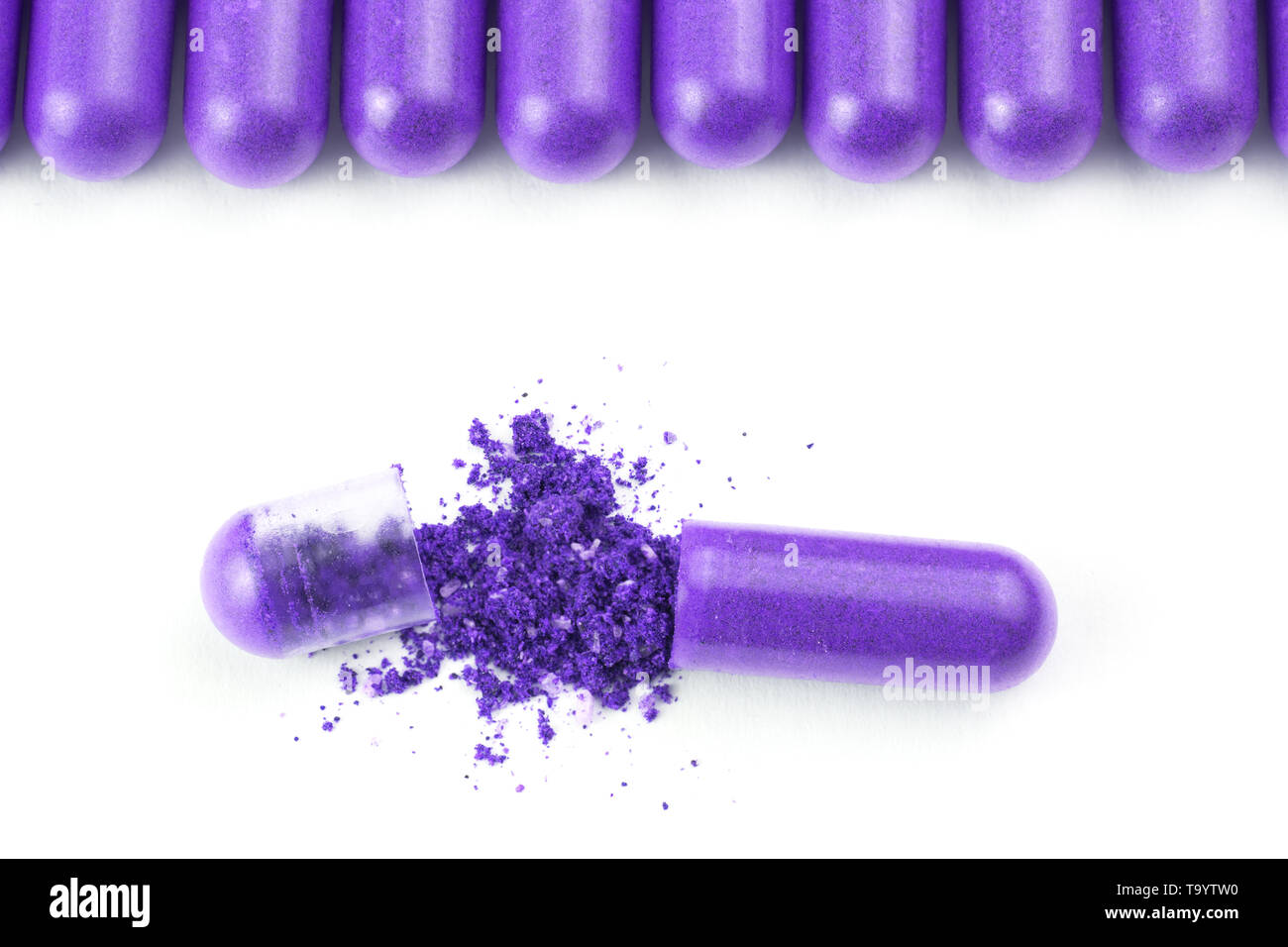 row of proton purple color organic capsules isolated on white ...