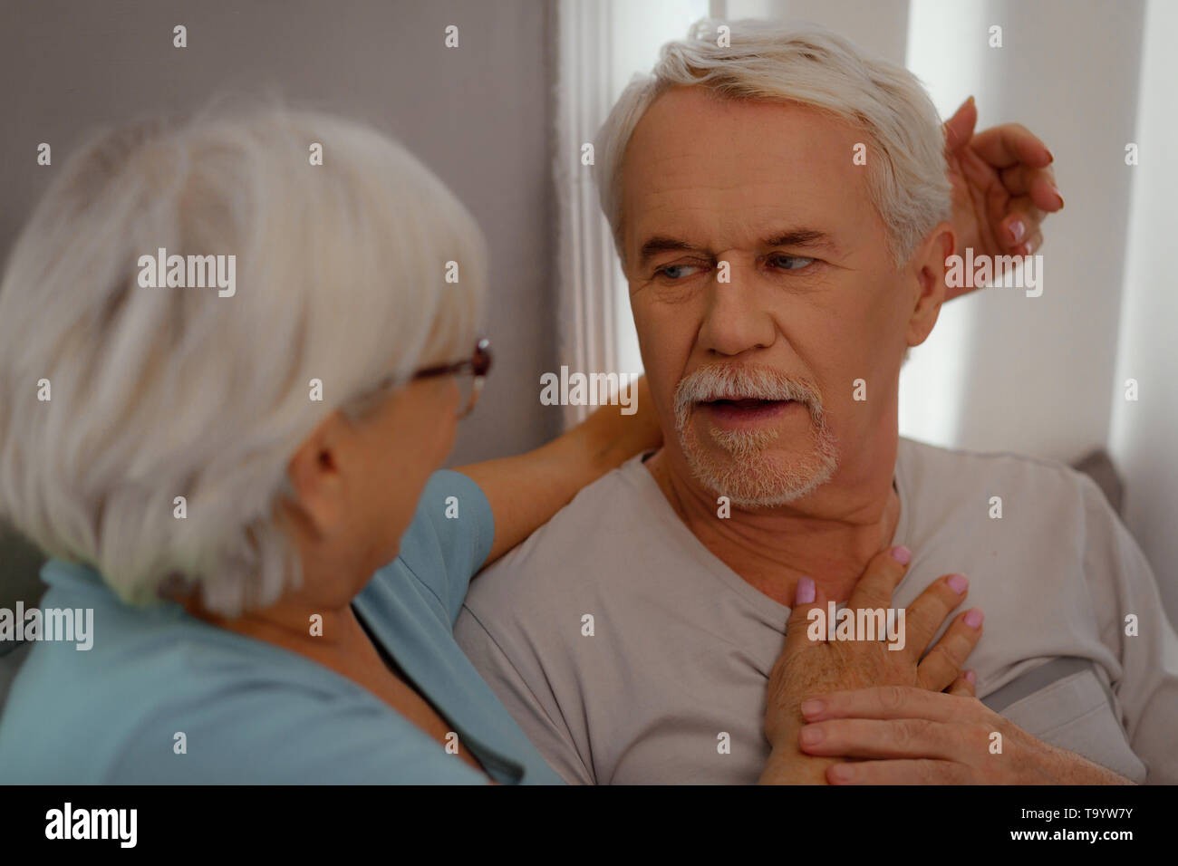 Loving man looking at his wife face and hugging her Stock Photo - Alamy