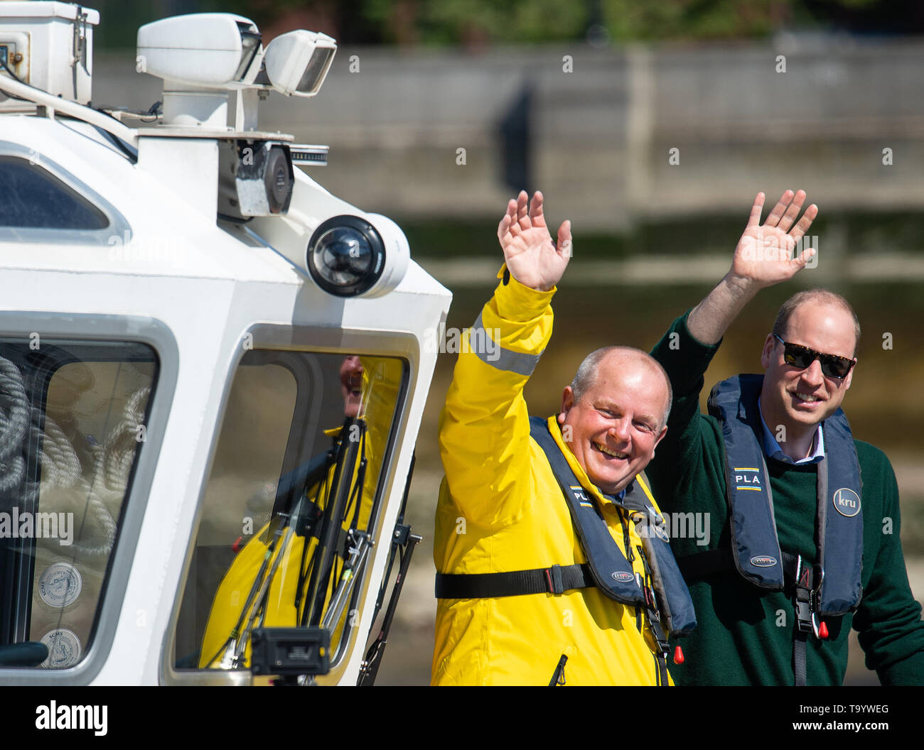 The Duke of Cambridge waves from a boat on the river Thames, during the ...