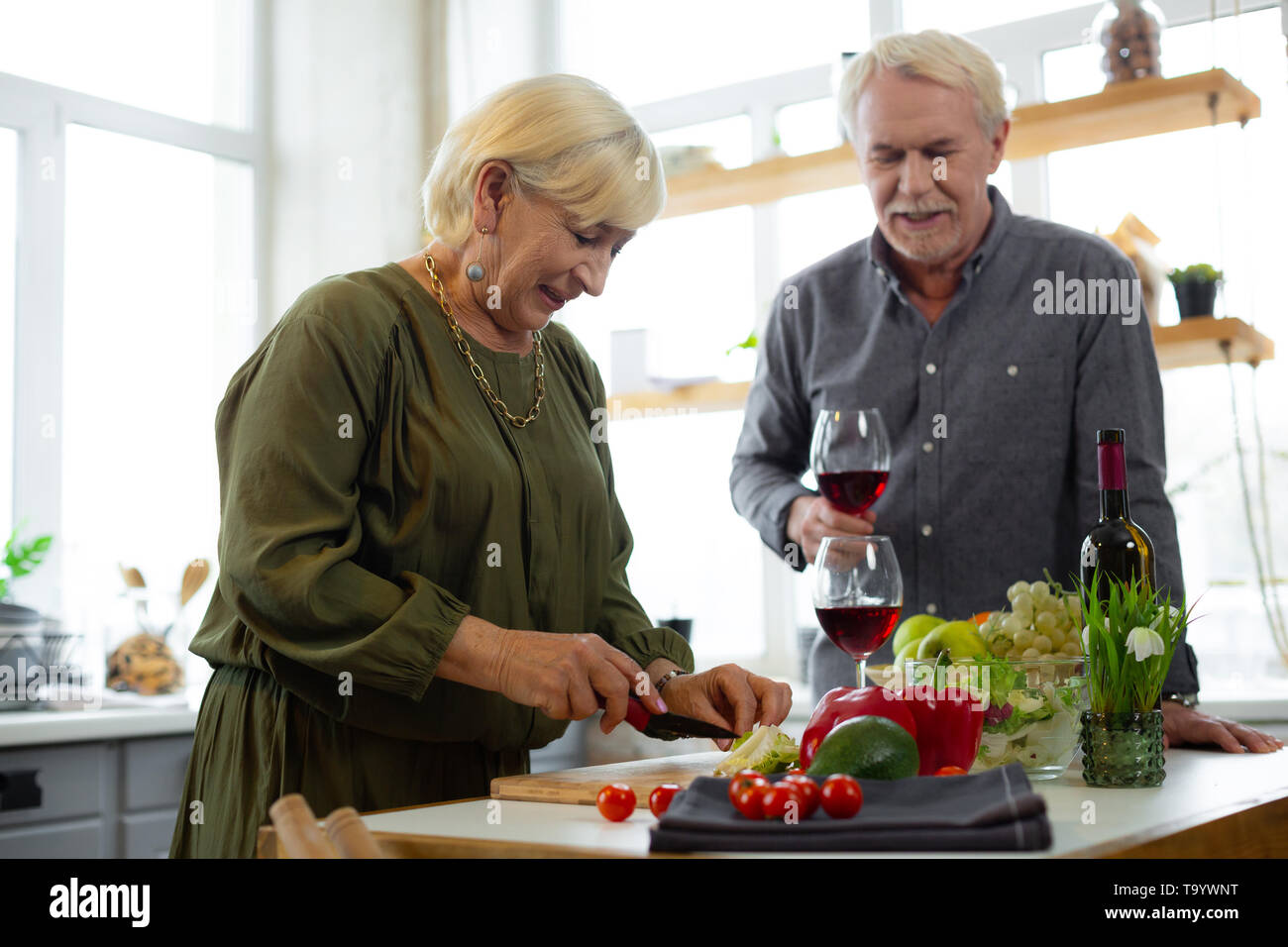 Bewitching woman cutting veggies for the romantic dinner Stock Photo ...