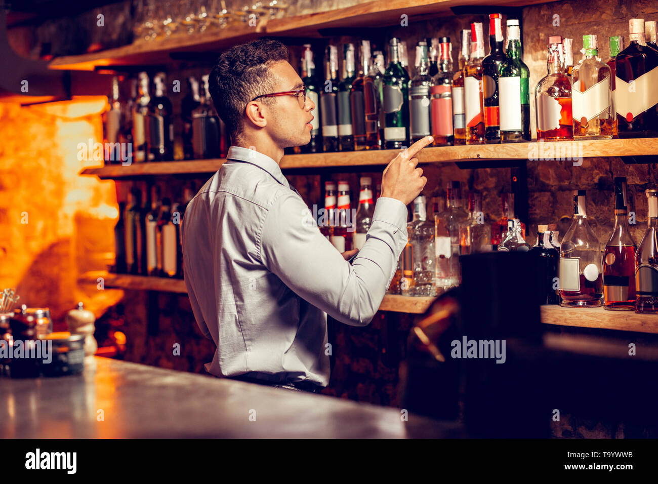 Man standing near bar stand and ordering alcohol for restaurant Stock ...