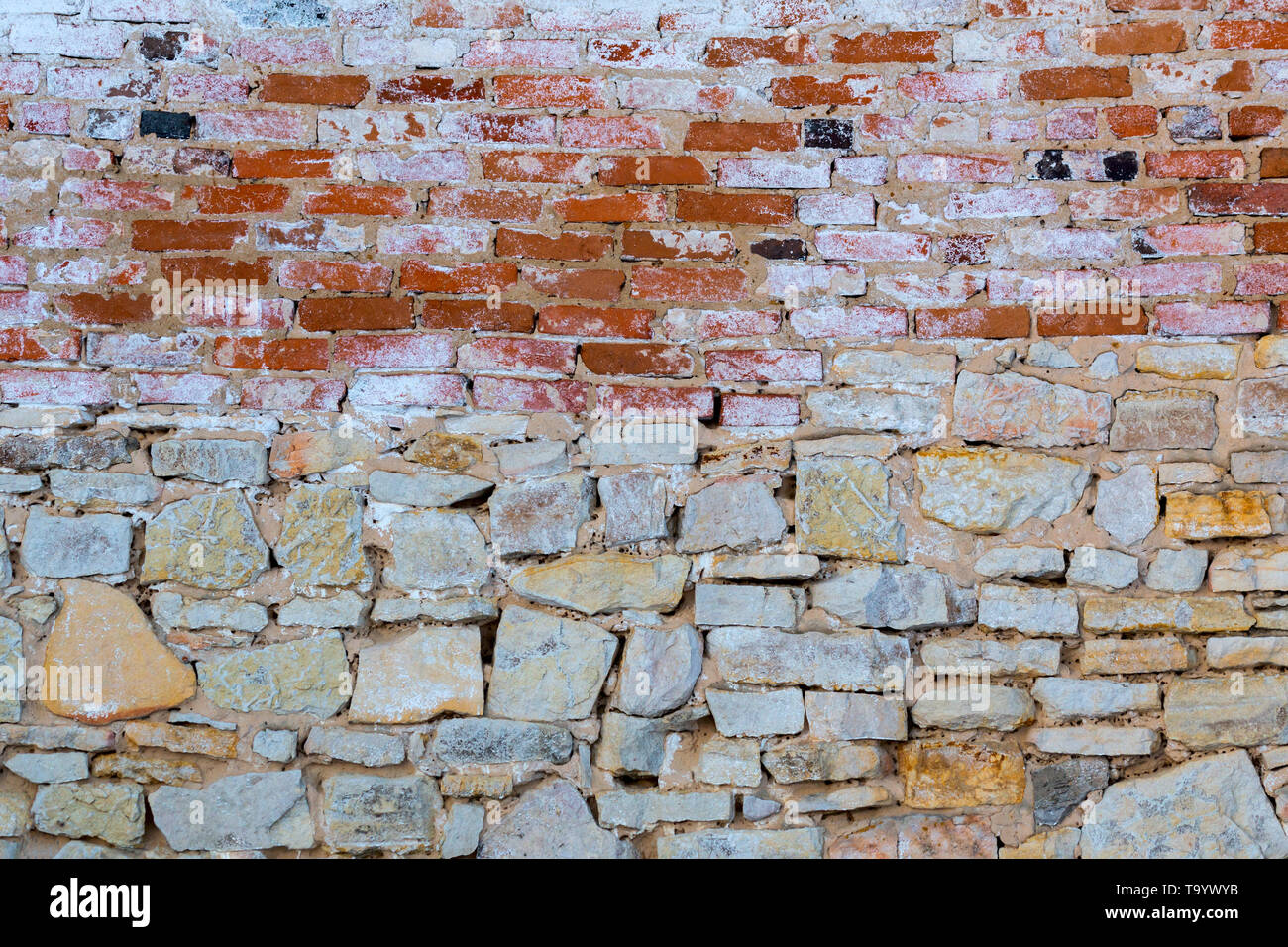 mixed used bricks and stone flat wall texture Stock Photo - Alamy
