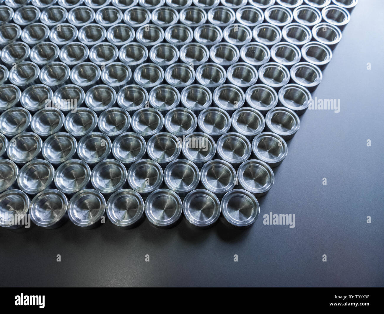 Shiny metal parts after cnc turning, on flat surface top-down flat lay ...