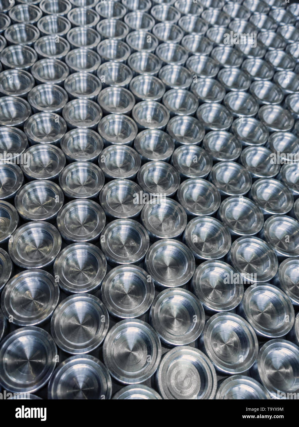 Shiny metal parts after cnc turning, on flat surface selective focus ...