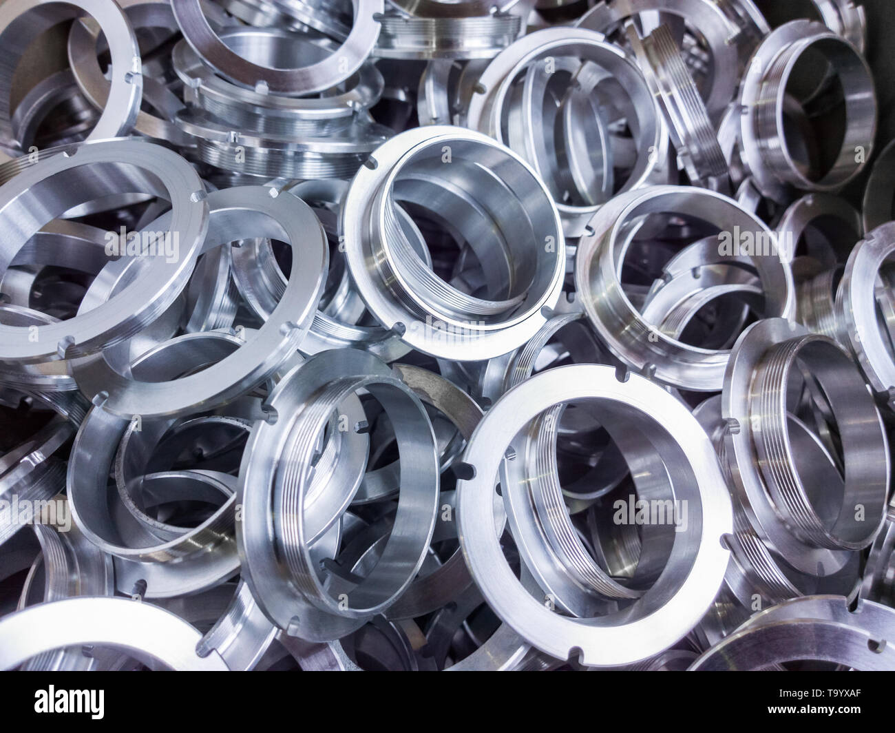 a batch of machined shiny aluminium parts with selective focus Stock ...
