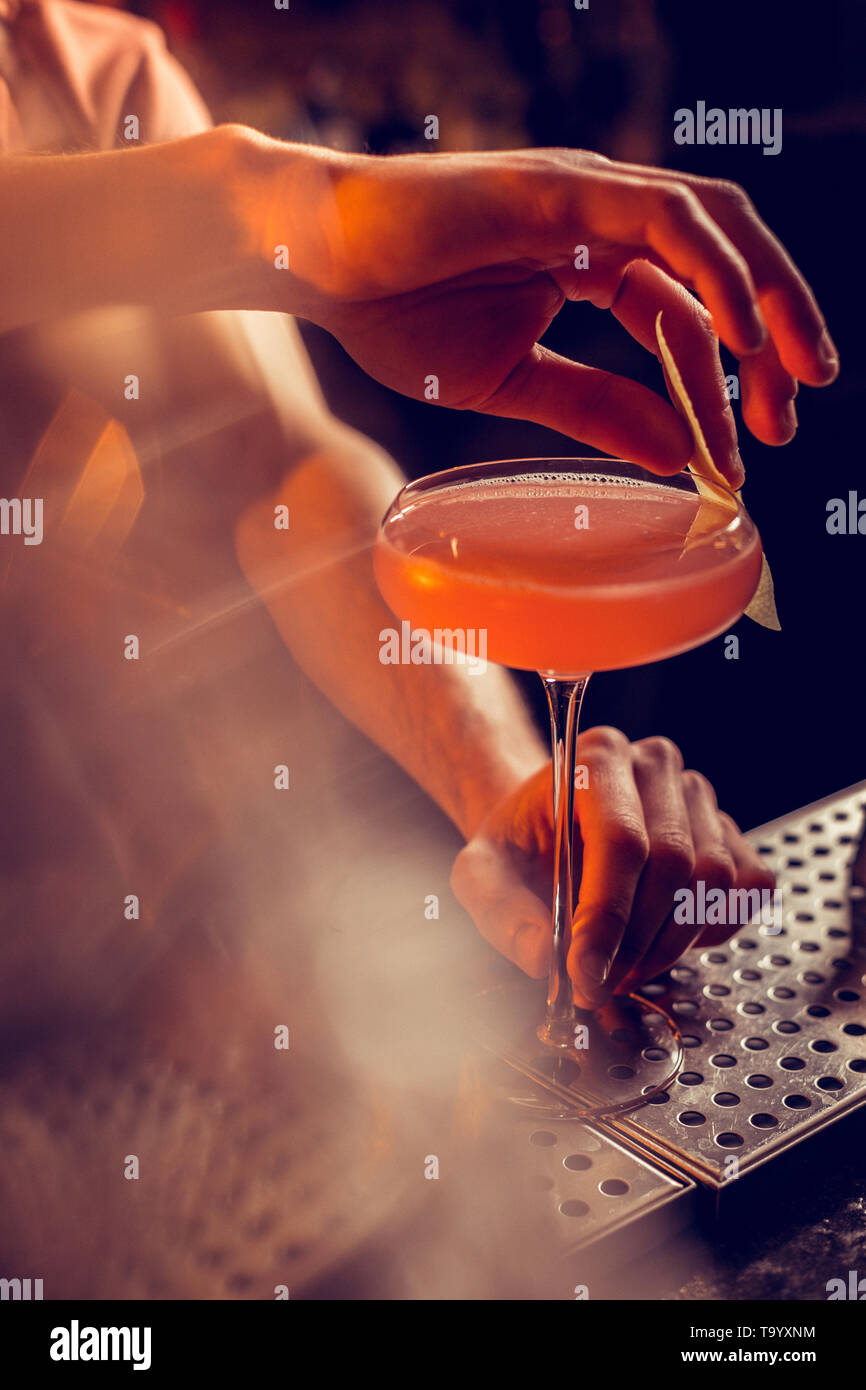 Top view of barman finishing nice alcohol fruit cocktail Stock Photo ...