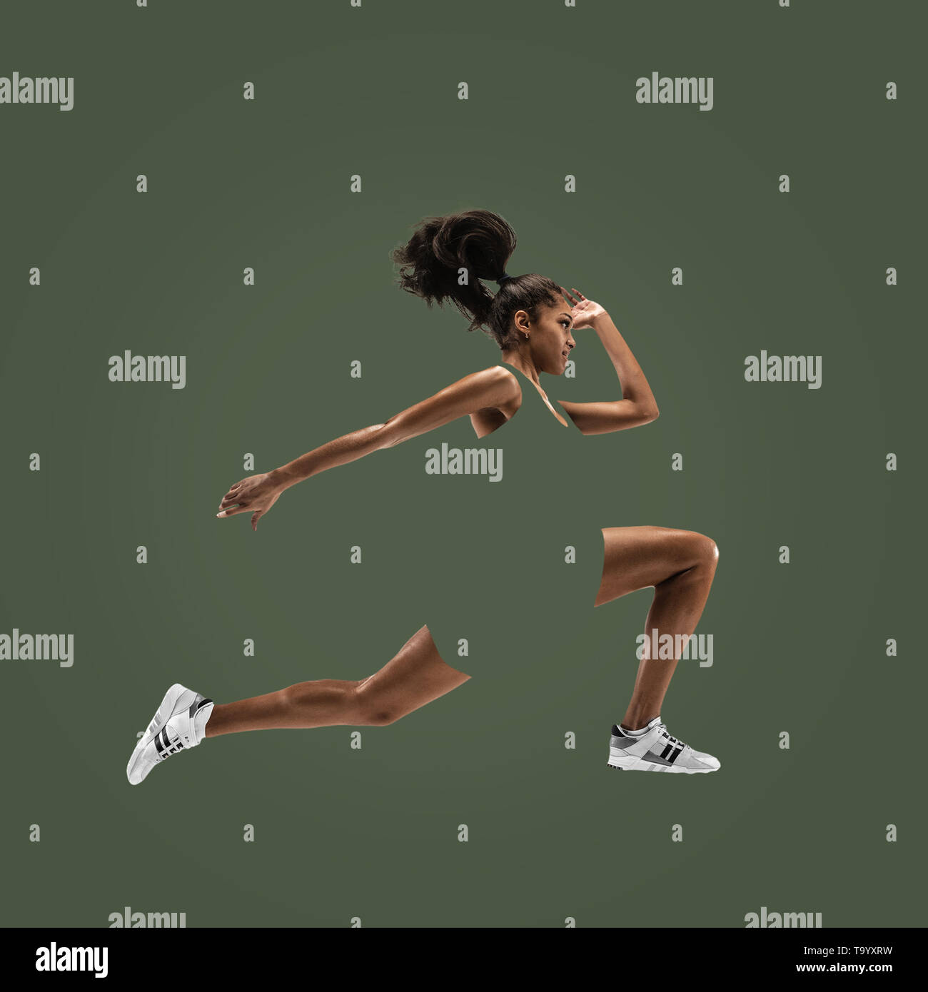 Young african woman running isolated on green studio background. One ...