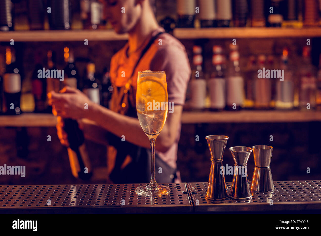 Cocktail with lemon standing on the bar stand Stock Photo - Alamy