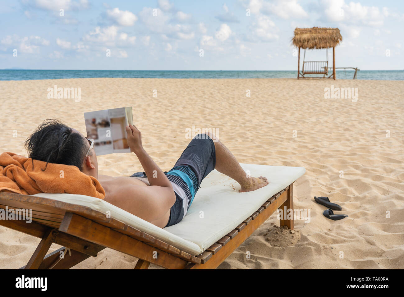 Man sunbathing reading book hi-res stock photography and images - Alamy
