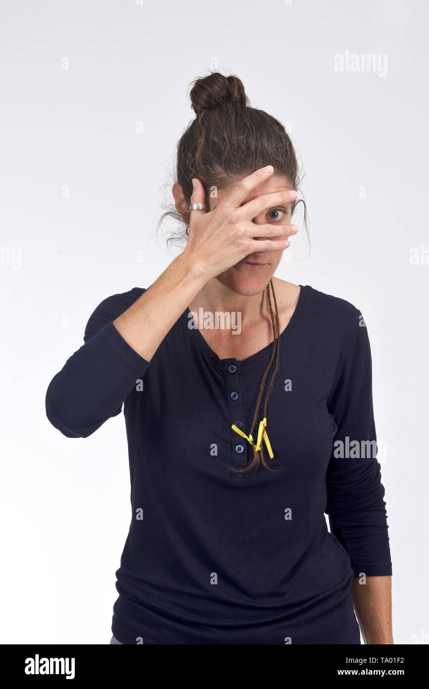 woman peeking with hand on face on white background Stock Photo - Alamy