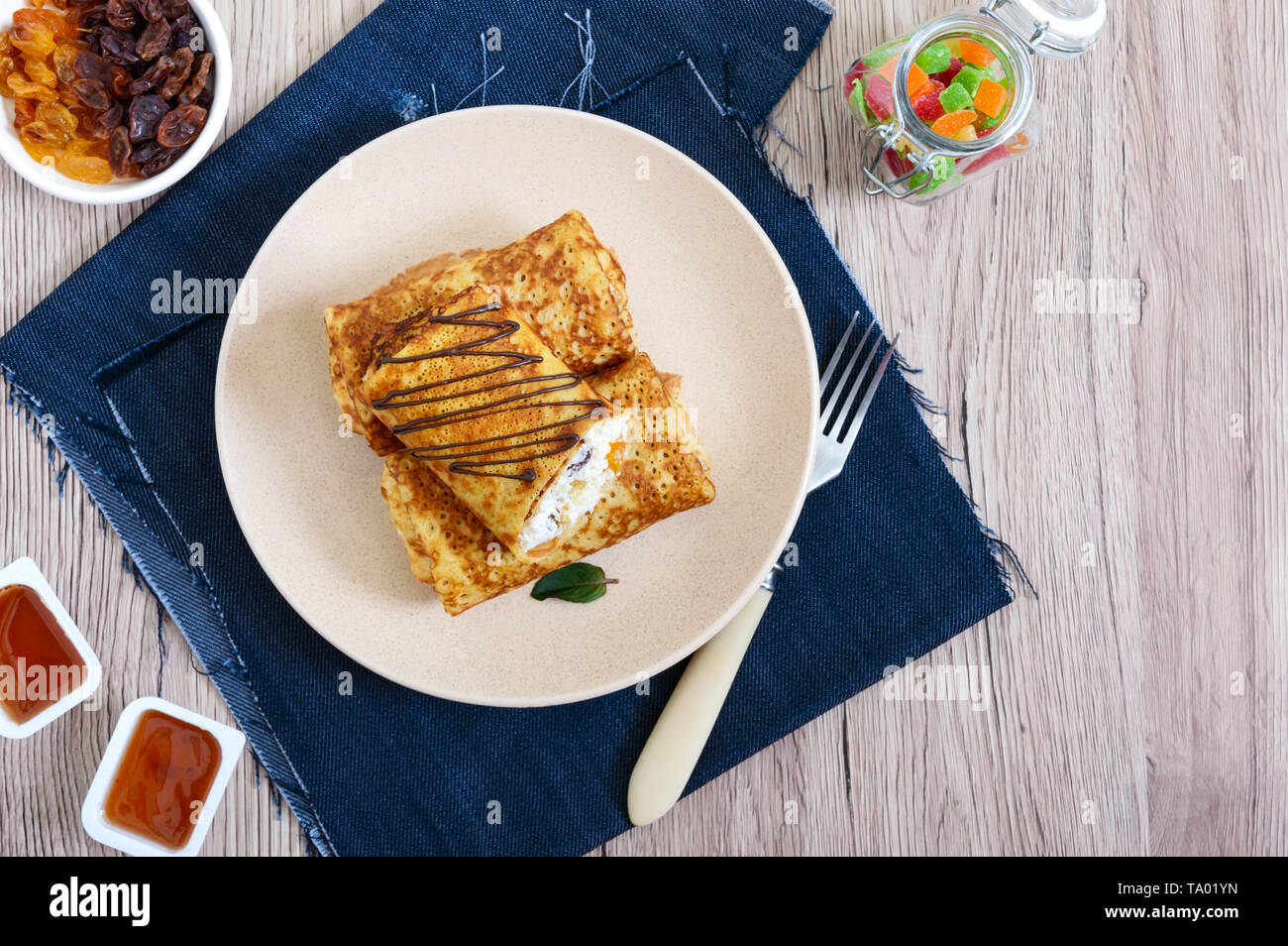 Delicious delicate pancakes with cottage cheese, vanilla and raisins on ...