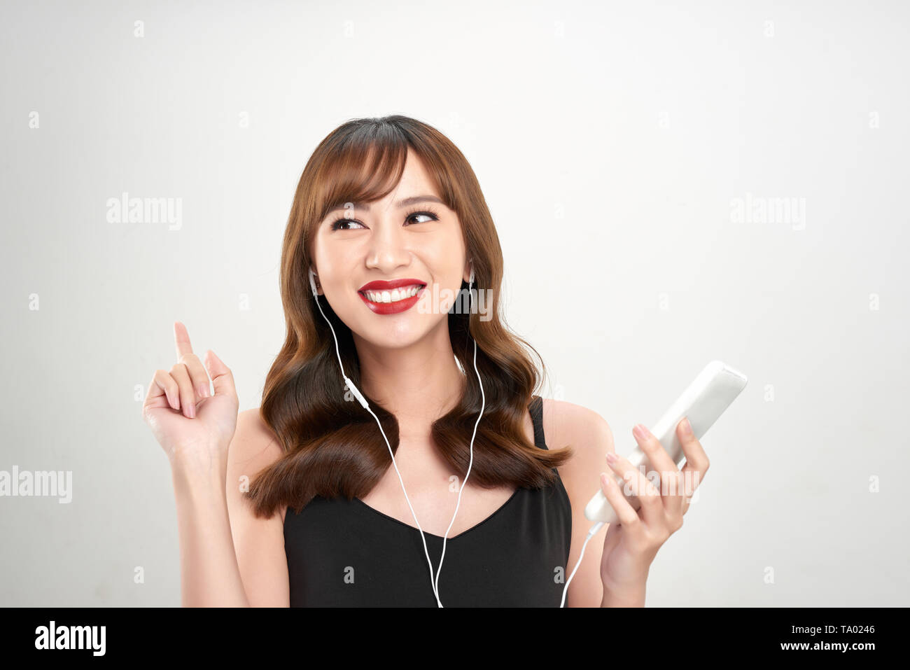 Happy asian Woman listening to music on headphones. Young fresh Asian ...