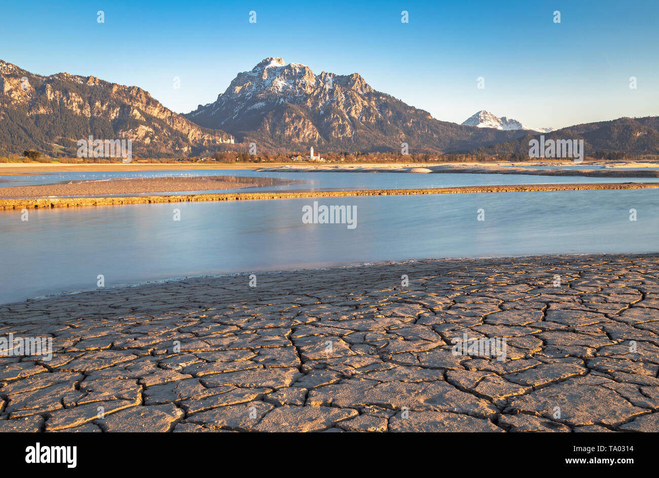 View over dry lake Forggensee to Neuschwanstein castle, Bavaria ...