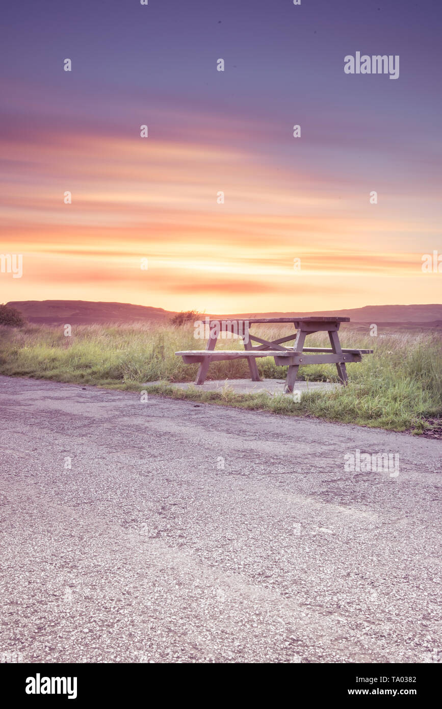 Wooden bench under stunning sunset clouds Stock Photo - Alamy