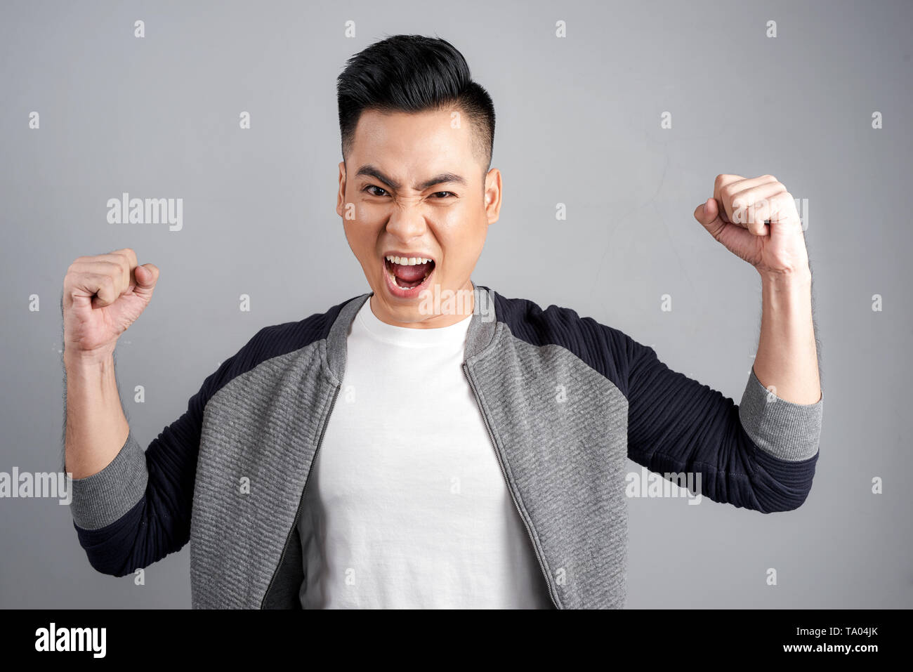 Happy handsome man cheering arms hi-res stock photography and images ...