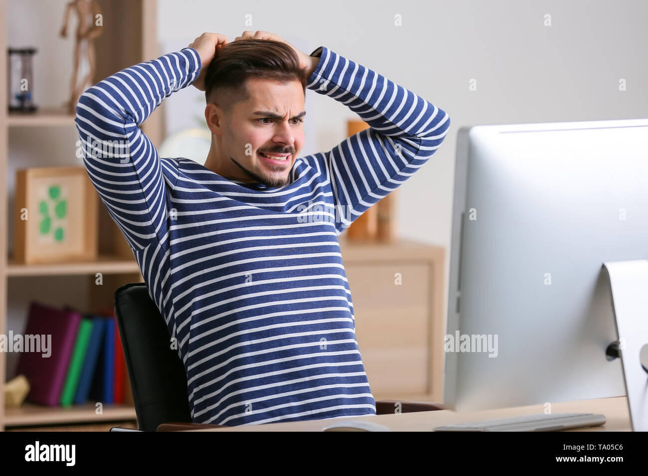 Displeased young man after losing computer game at home Stock Photo - Alamy