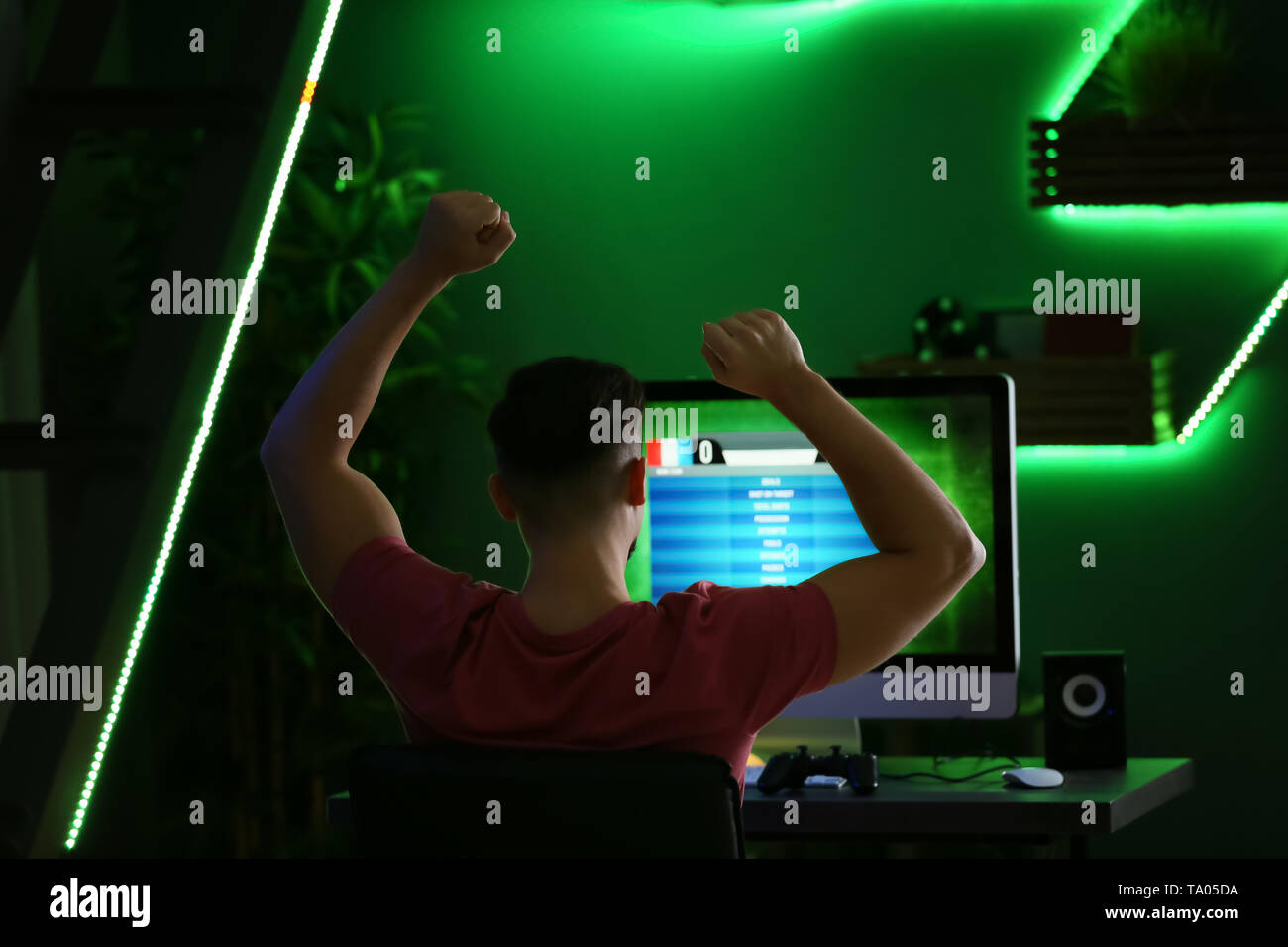 Happy young man after winning computer game in club Stock Photo - Alamy