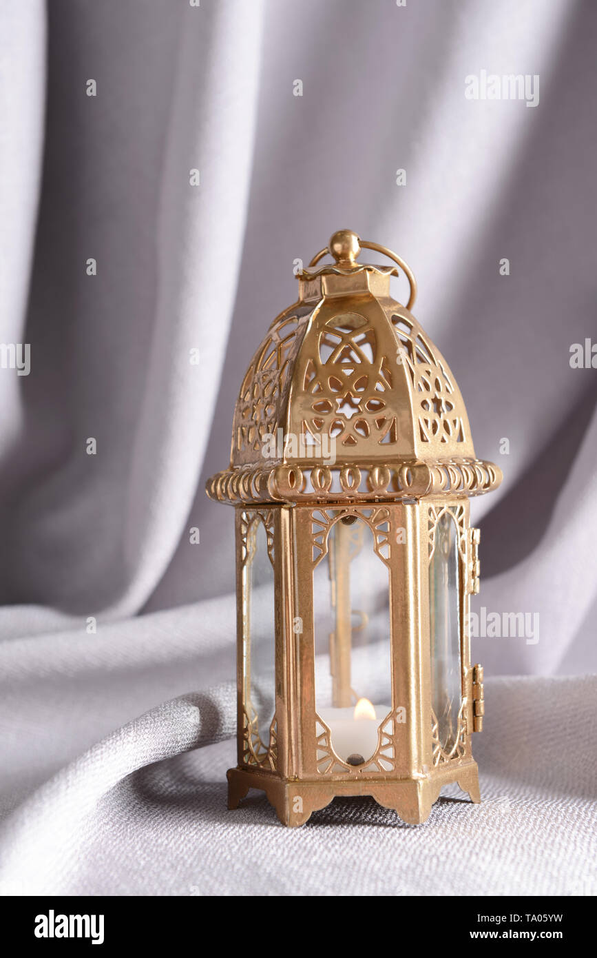 Muslim lantern on light fabric Stock Photo - Alamy