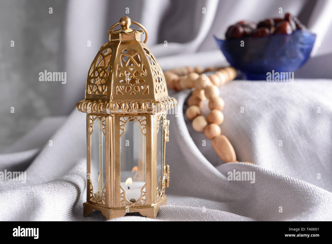 Muslim lantern on light fabric Stock Photo - Alamy