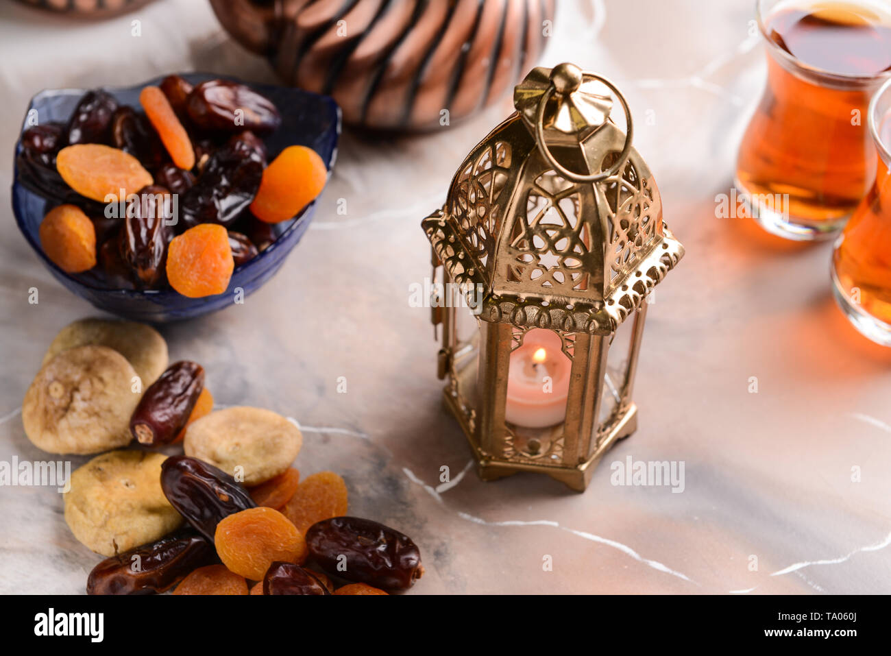 Muslim lantern with dried fruits and tea on table Stock Photo - Alamy