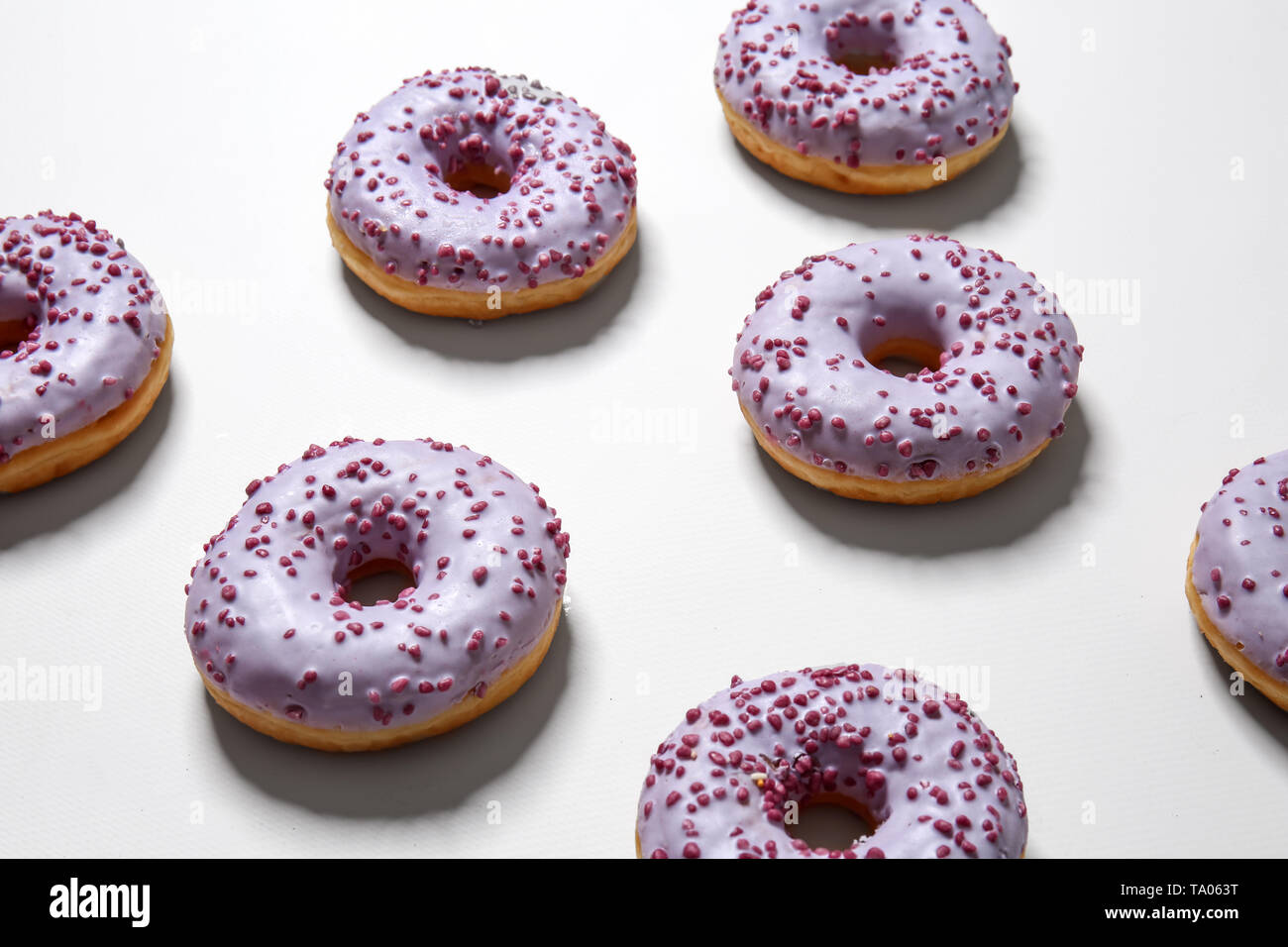 Many tasty doughnuts on white background Stock Photo - Alamy
