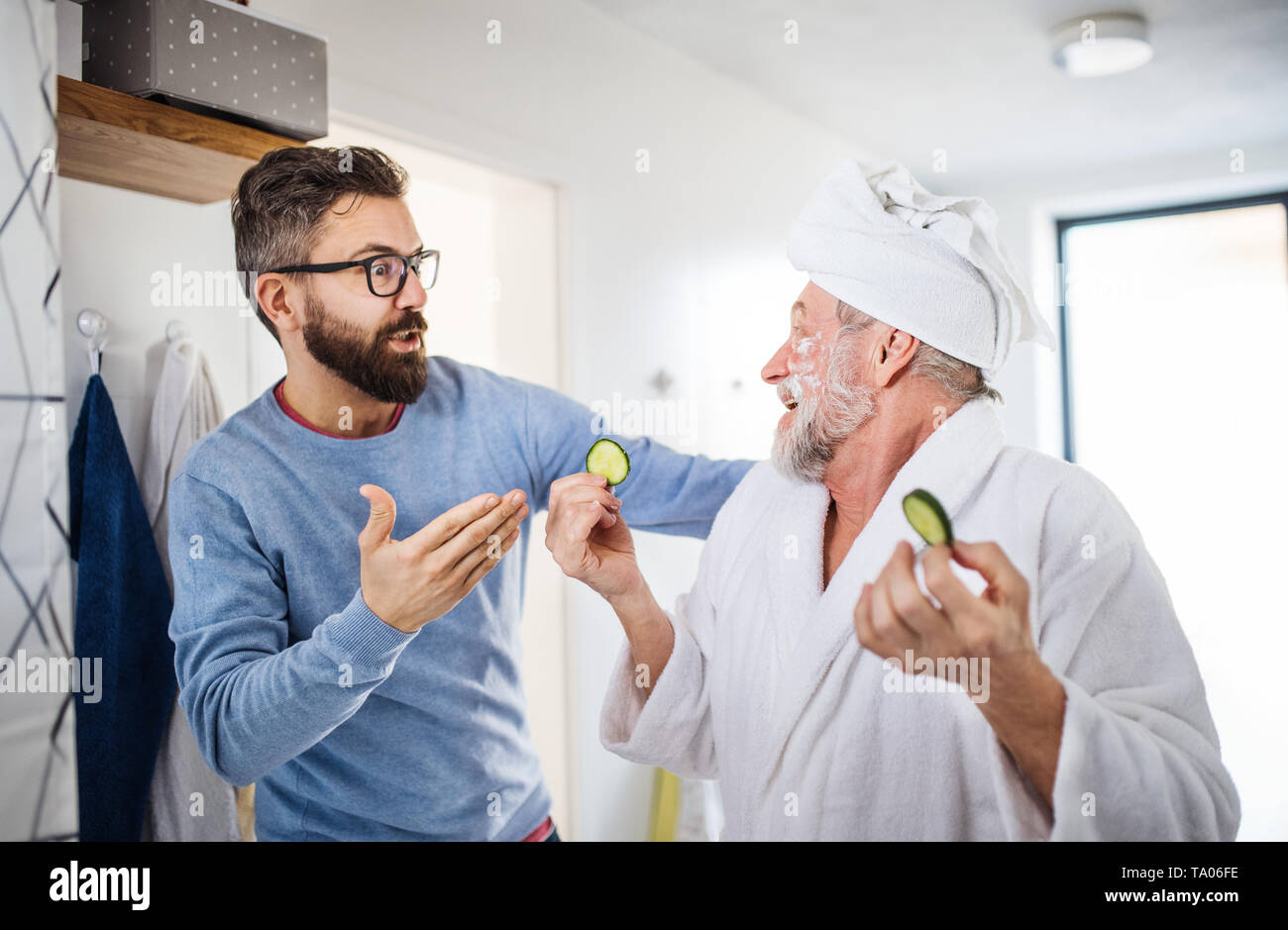 A Cheerful Adult Hipster Son And Senior Father In Bathroom Indoors At