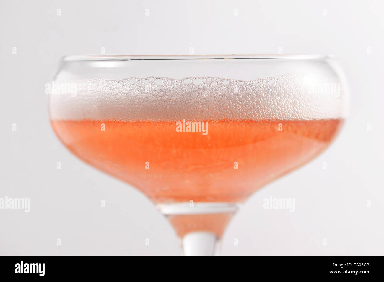 Glass of pink sparkling wine on white Stock Photo - Alamy