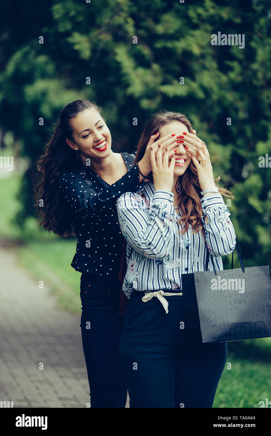 Girl make emotional surprise to her bestfriend covering eyes with hands ...