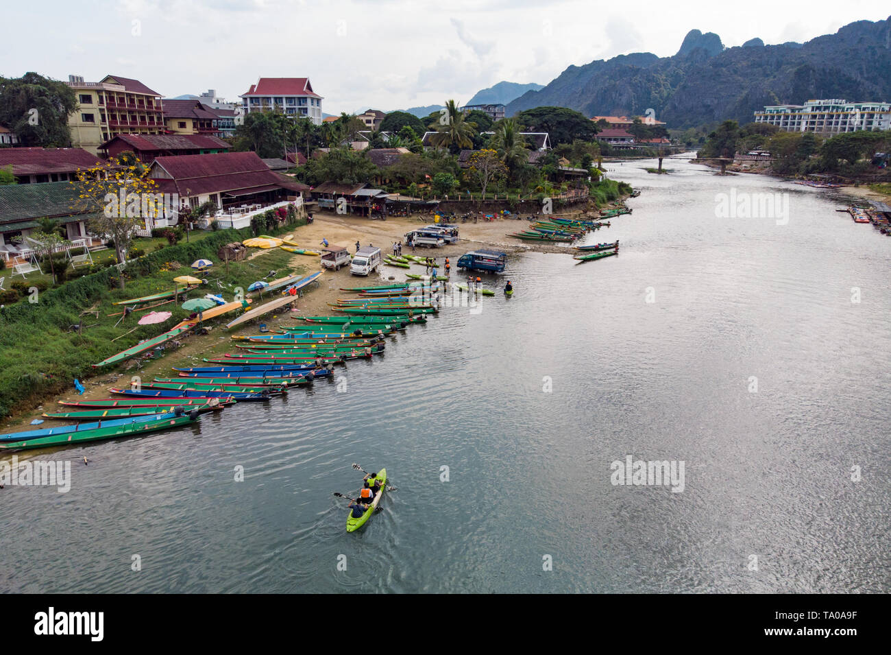 Stunning aerial view of two tourists who are kayaking on the river that ...