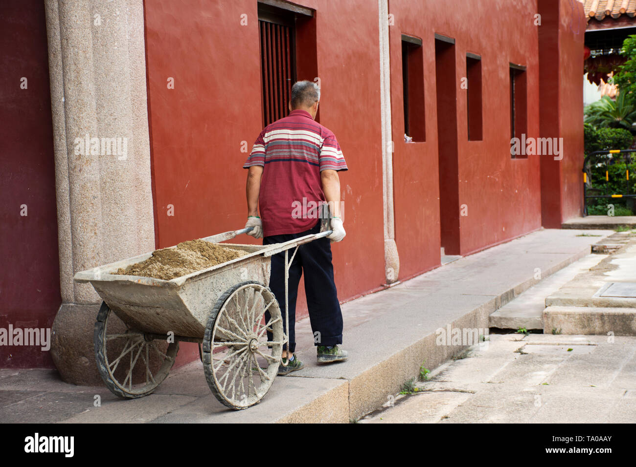 Chinese old men pulling cart carry sand go to construction site for ...