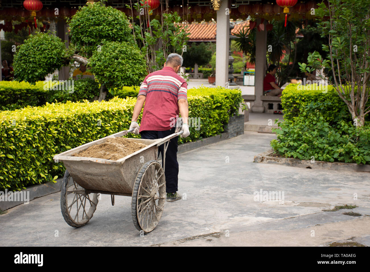 Chinese old men pulling cart carry sand go to construction site for ...