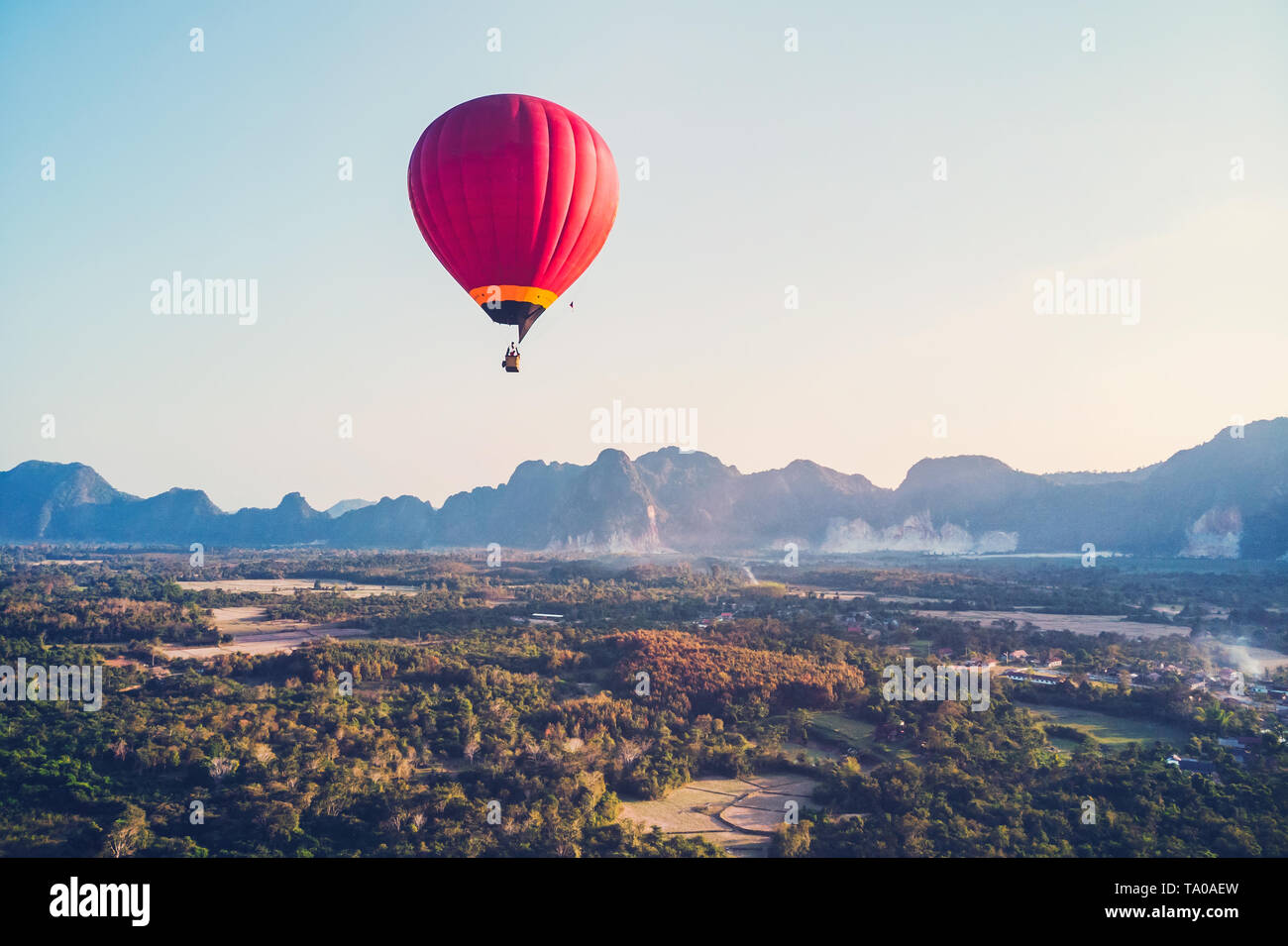 red hot-air balloon raising just in time to explore the beautiful ...